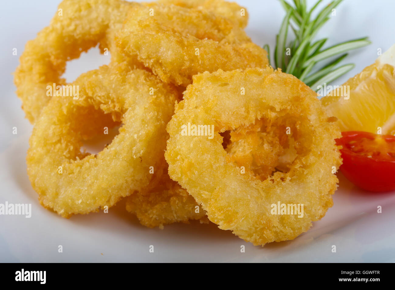 Fried Calamari rings with rosemary and lemon Stock Photo - Alamy
