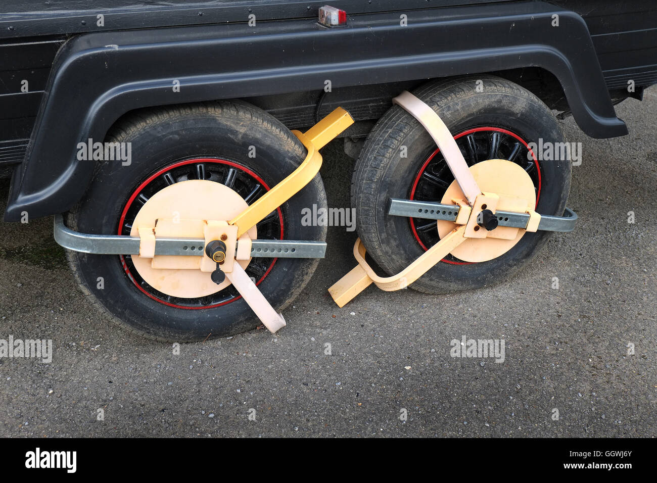 Two wheel clamps on trailer Stock Photo - Alamy