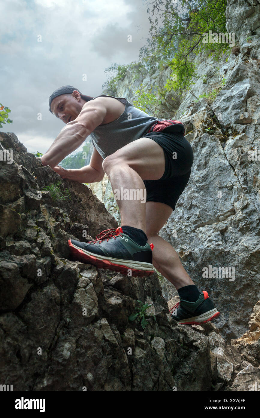 Man climbing cliff face hi-res stock photography and images - Alamy