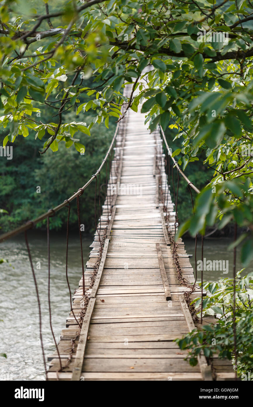 Wooden footbridge over a river with selective focus Stock Photo - Alamy