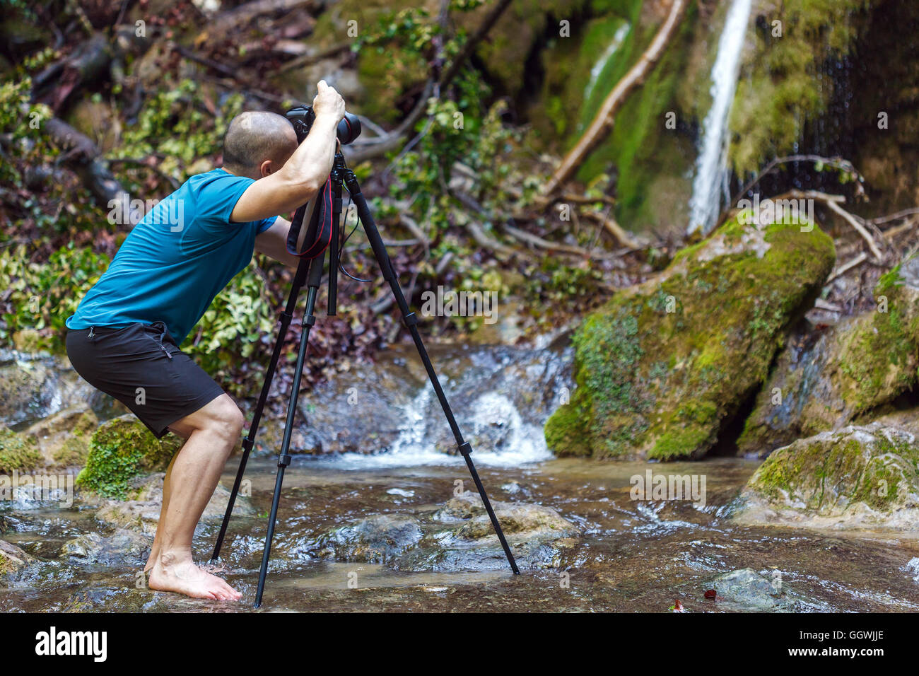 Professional landscape photographer with camera on tripod shooting a ...