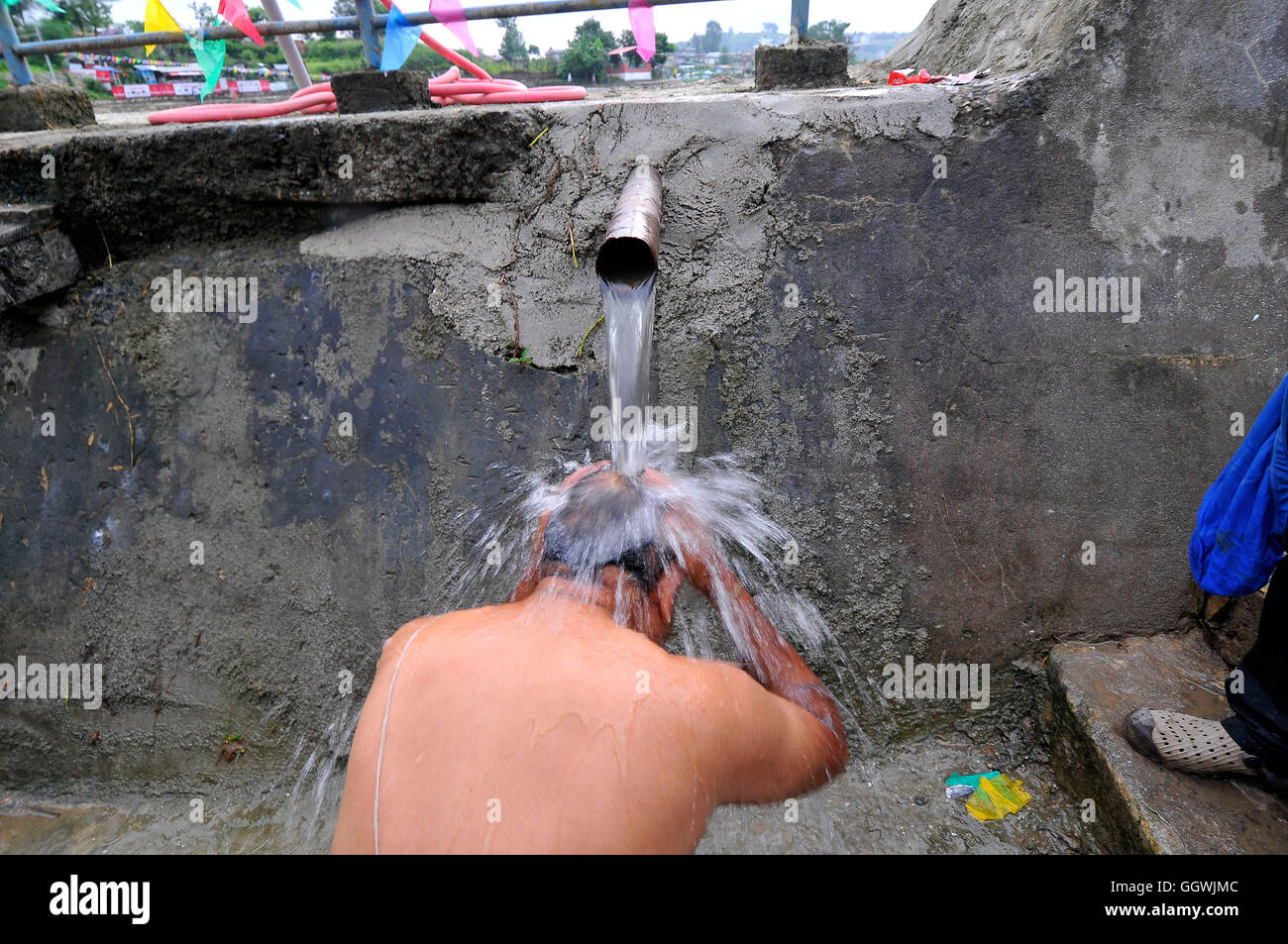 Kathmandu, Nepal. 07th Aug, 2016. A Nepalese devotees taking holy bath ...