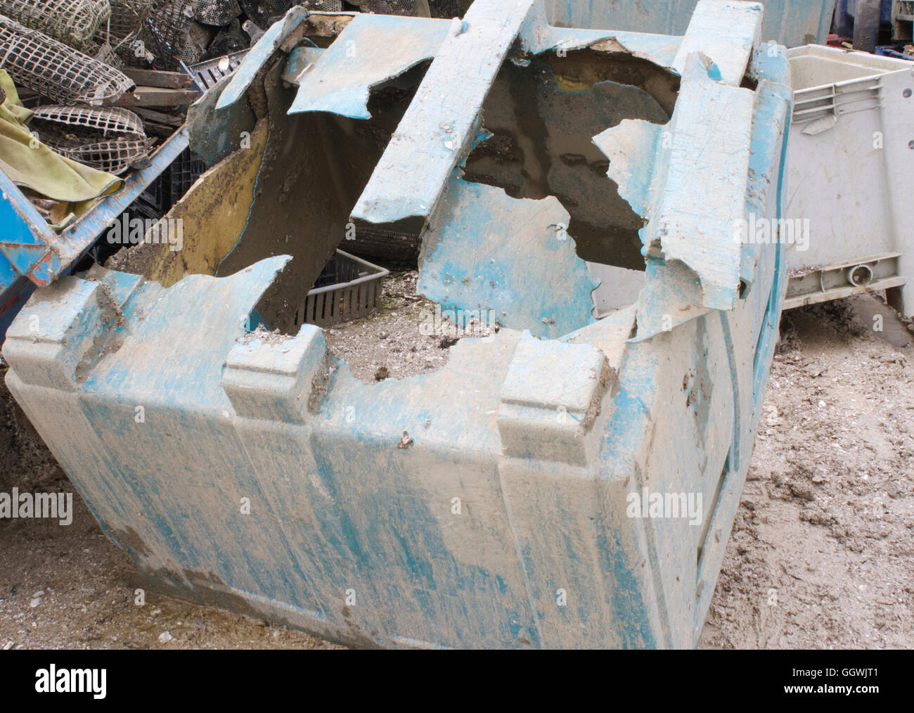 Large garbage bin with busted bottom Stock Photo - Alamy