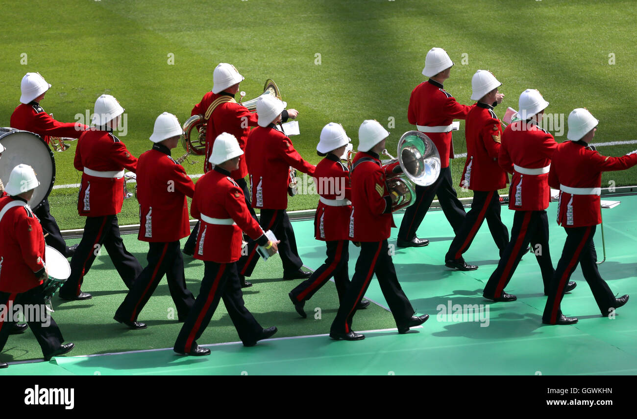 A band perform around the outside of the pitch before the Betway Cup ...