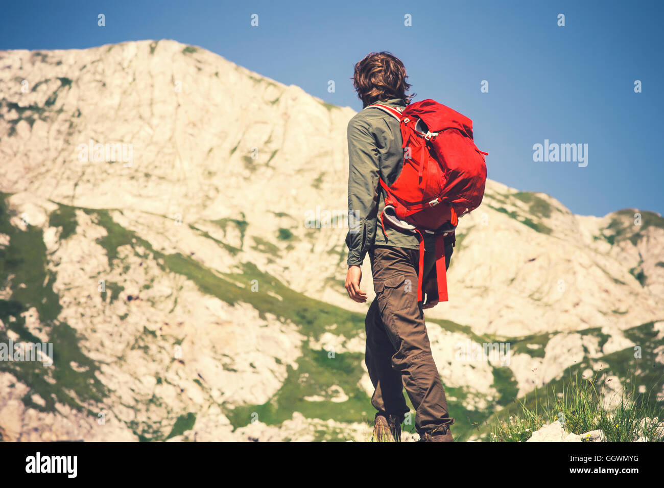 Man Traveler with red backpack climbing Travel Lifestyle concept rocky ...