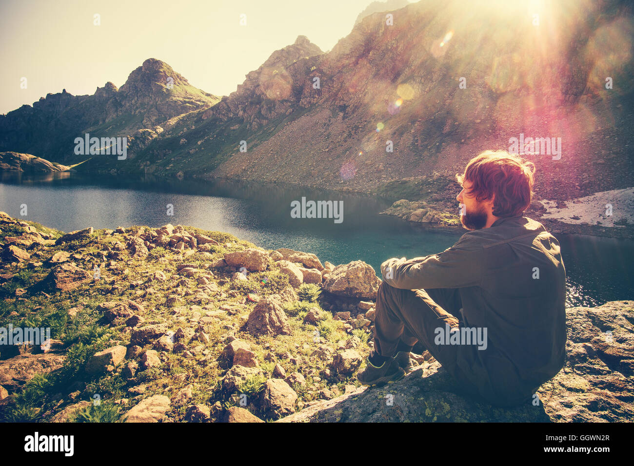 Traveler Man relaxing alone Travel Lifestyle concept lake and mountains ...