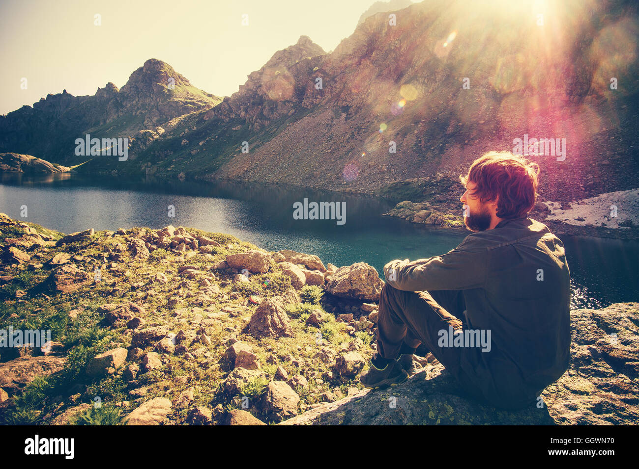 Traveler Man relaxing alone Travel Lifestyle concept lake and mountains ...
