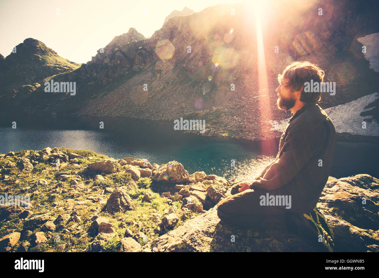 Bearded Man meditating relaxing alone healthy Lifestyle concept lake ...