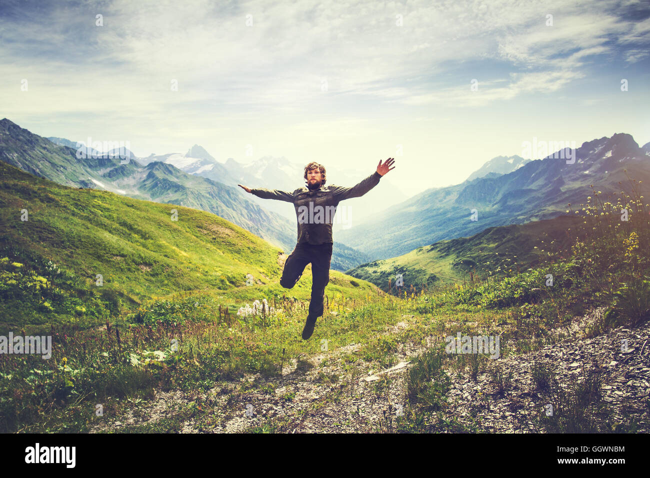 Traveler Man jumping with mountains landscape on background Lifestyle ...