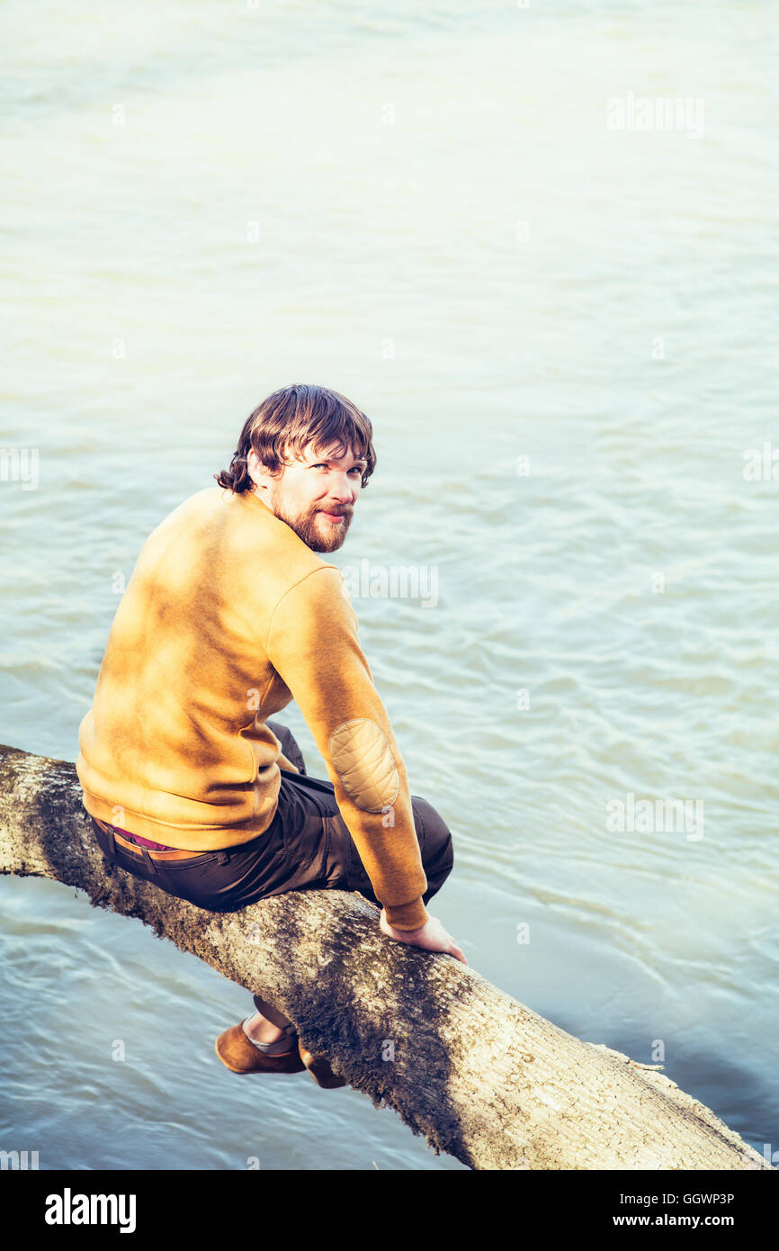 Young Man relaxing alone outdoor Lifestyle Travel concept lake on ...