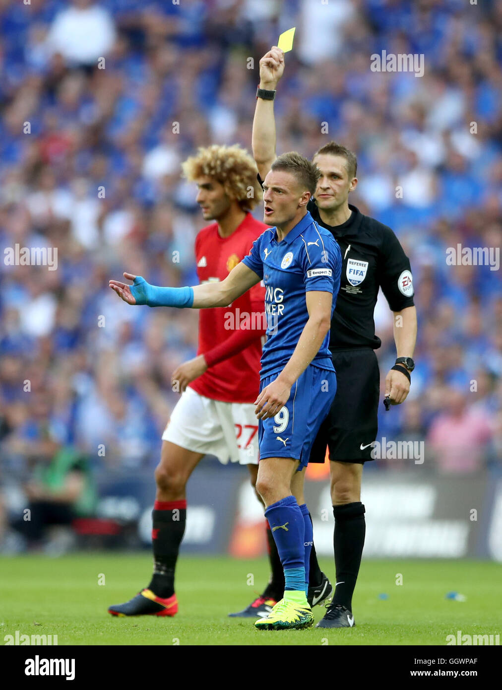 Leicester City's Jamie Vardy is shown the yellow card by referee Craig Pawson during the ...