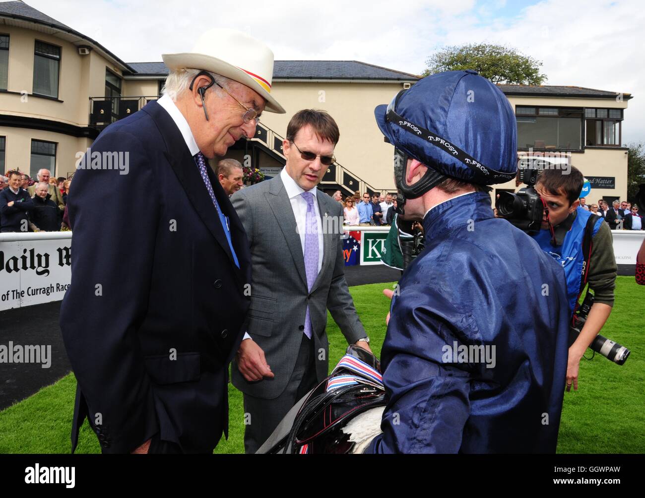 Owners John Magnier and Derrick Smith talk with jockey Seamus Heffernan ...