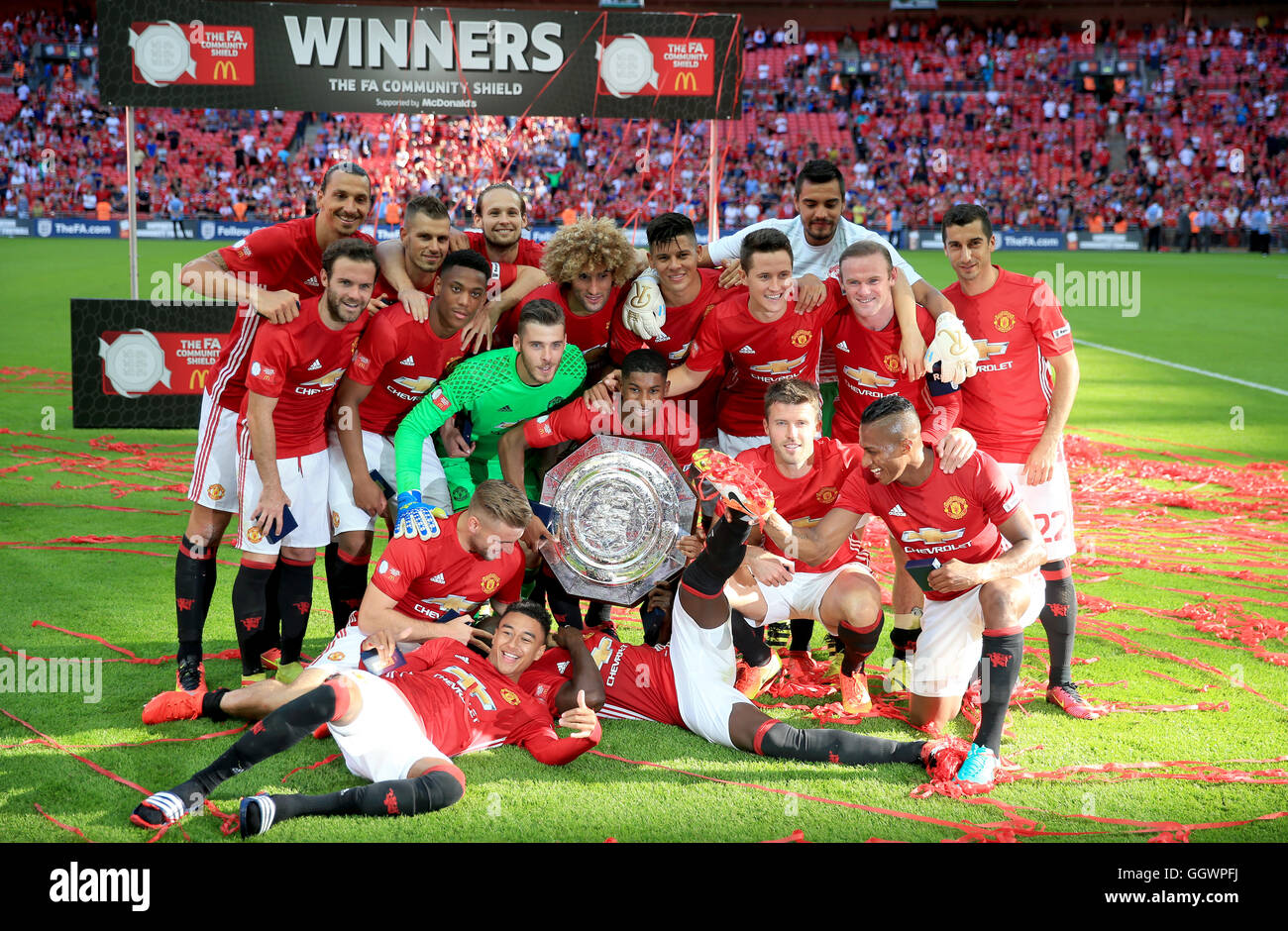 Manchester United players celebrate with the Community Shield after the ...