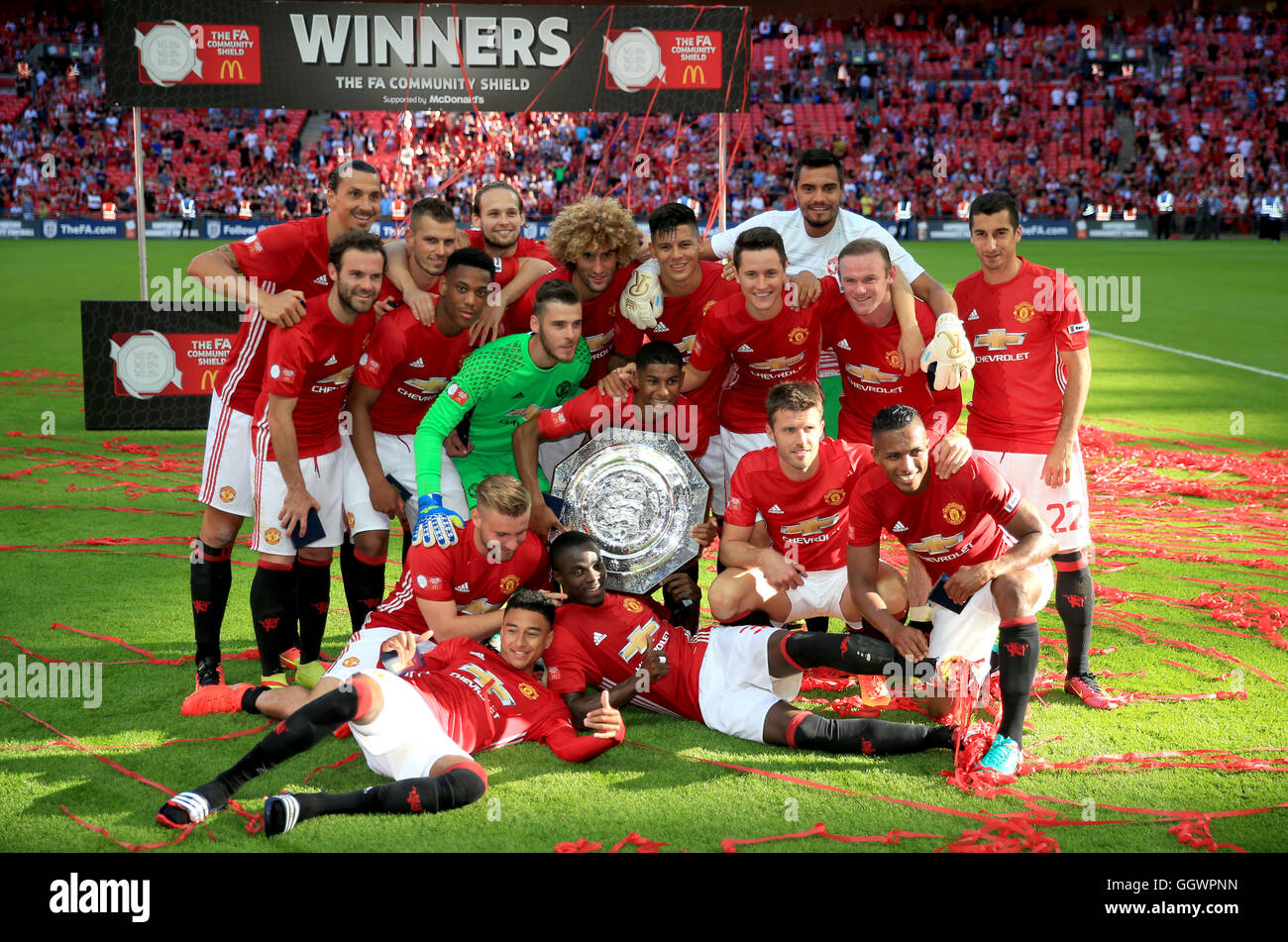 Manchester United players celebrate with the Community Shield after the ...