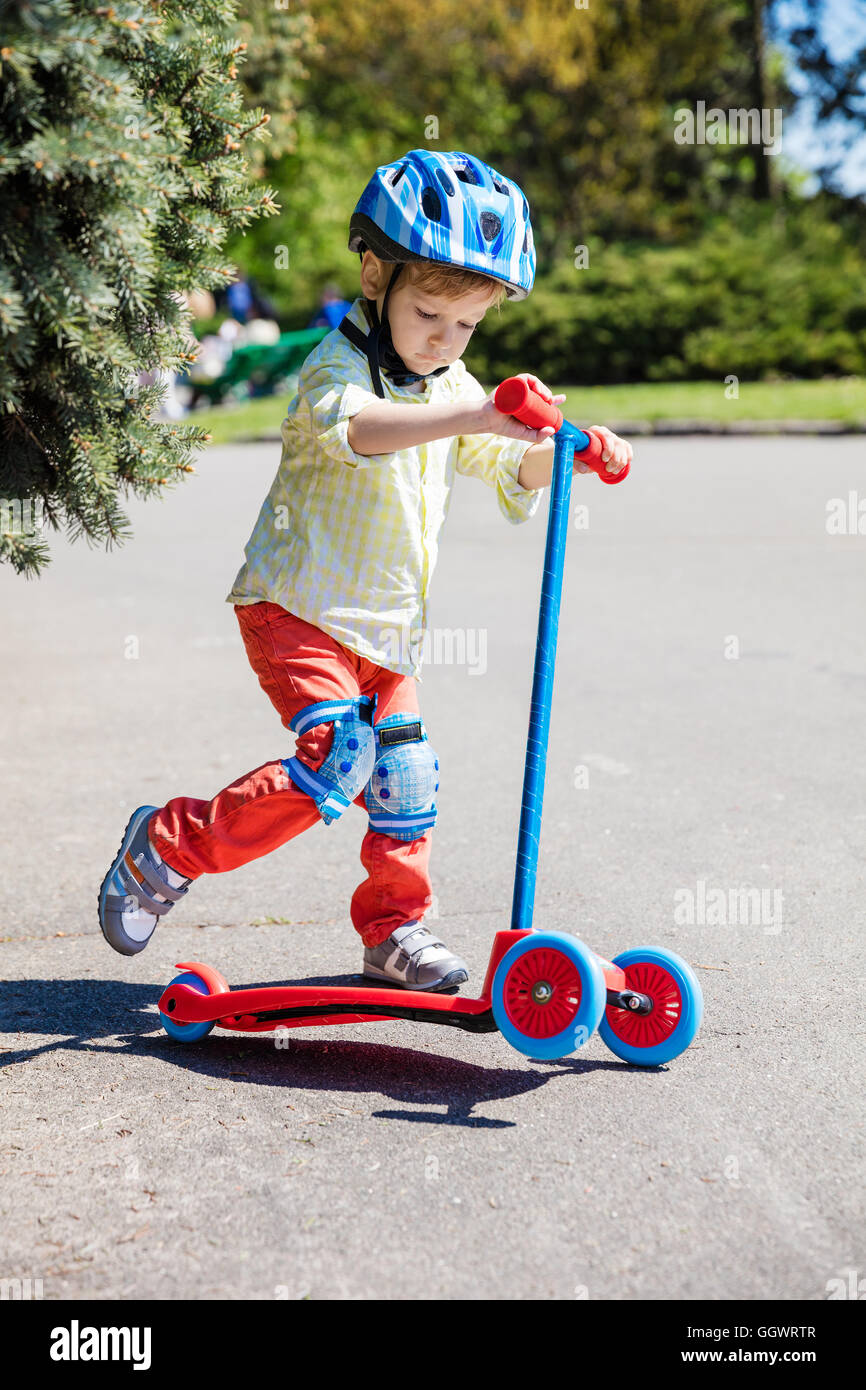 Little boy with a scooter outdoors Stock Photo - Alamy