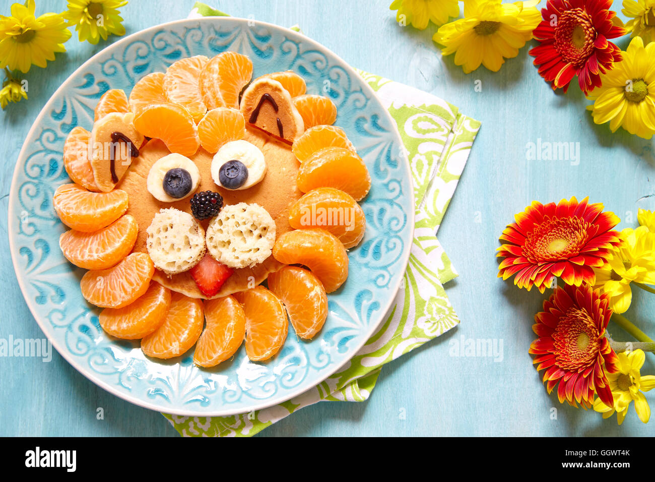 Funny lion pancake with mandarins and berries Stock Photo - Alamy