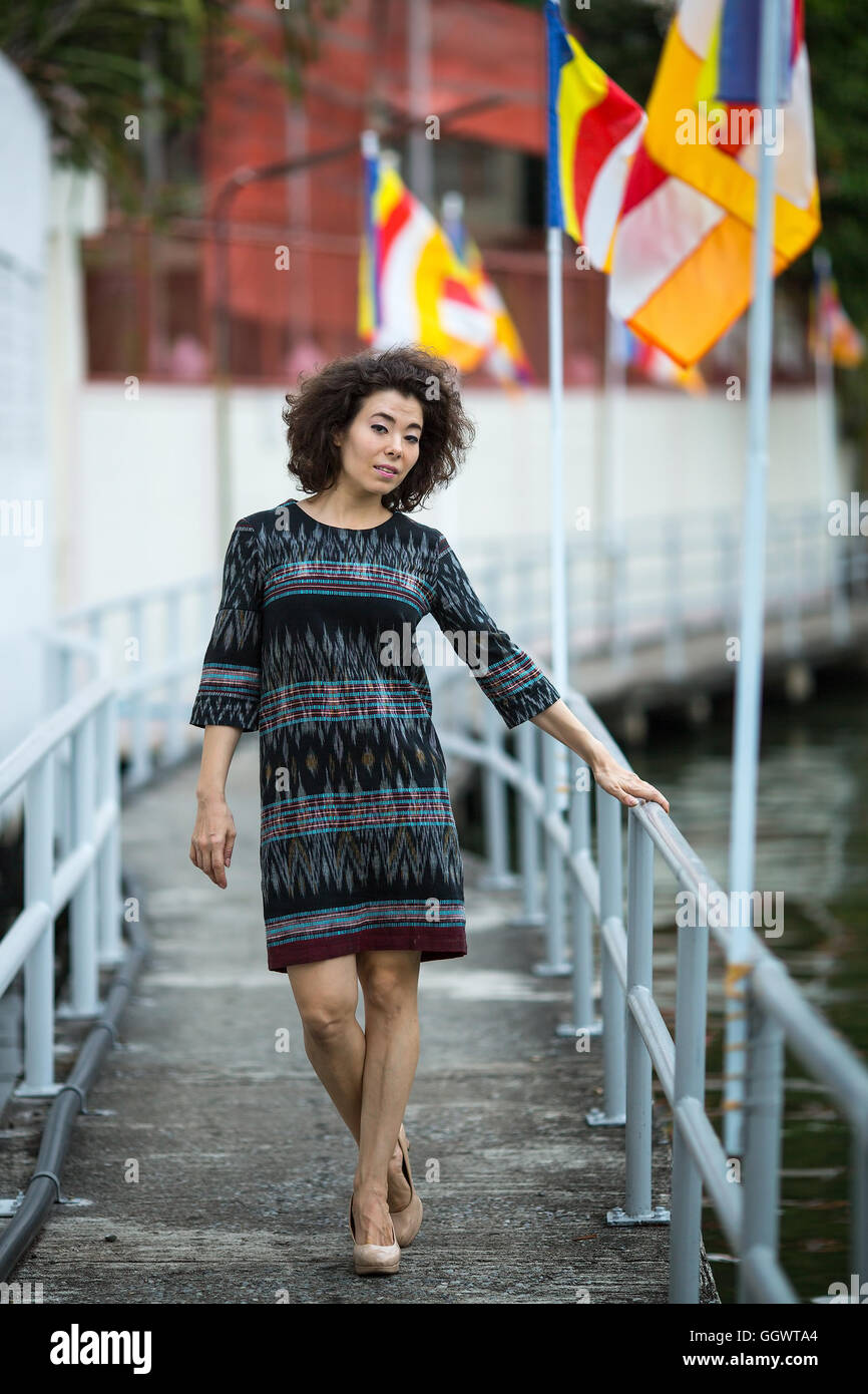 Young asian woman on the embankment of the river in Bangkok Stock Photo ...
