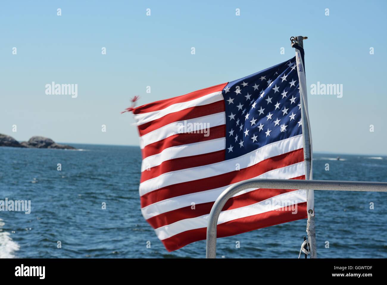 The United States Flag blowing in the wind over the Atlantic Ocean ...
