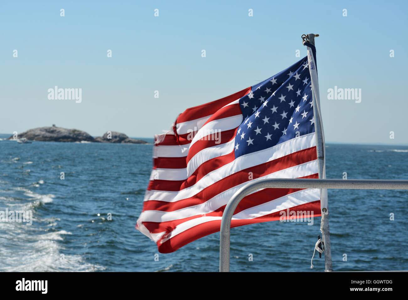 The United States Flag blowing in the wind over the Atlantic Ocean ...