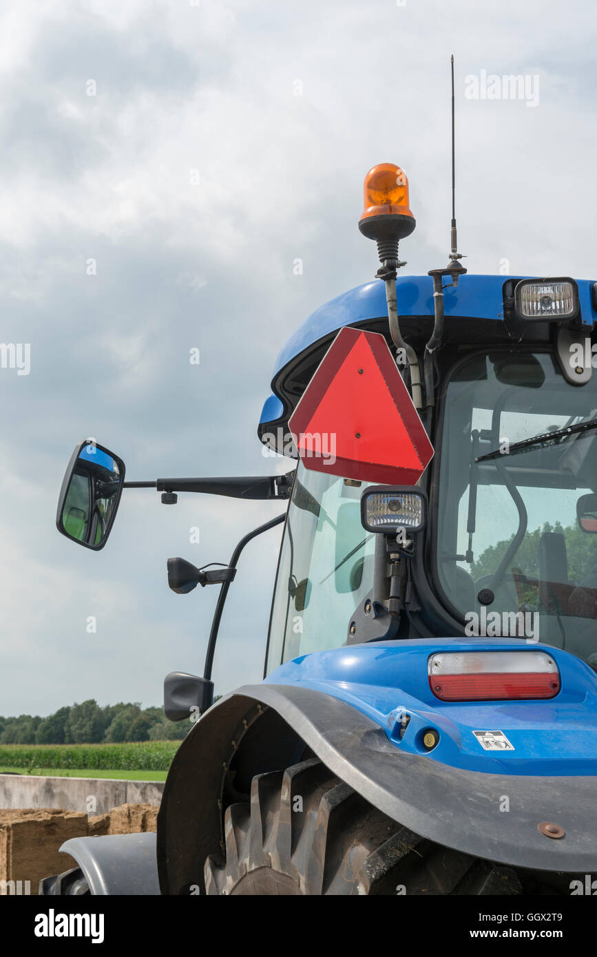Blue tractor with detail of the truncated warning triangle for motor ...