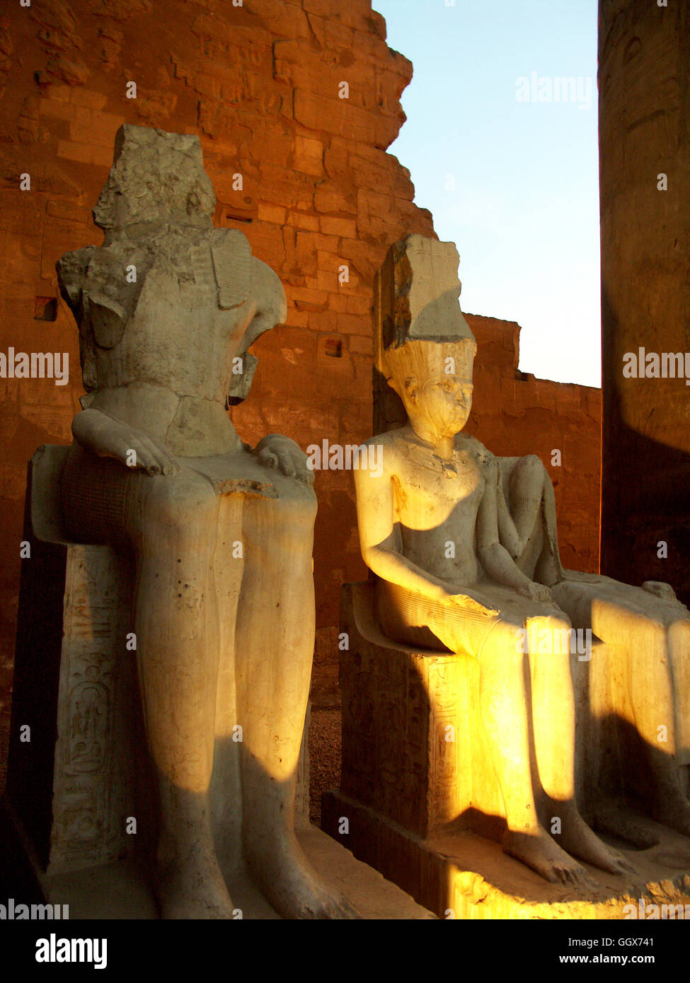 Seated statues of Amun and Mut at the processional colonnade of ...