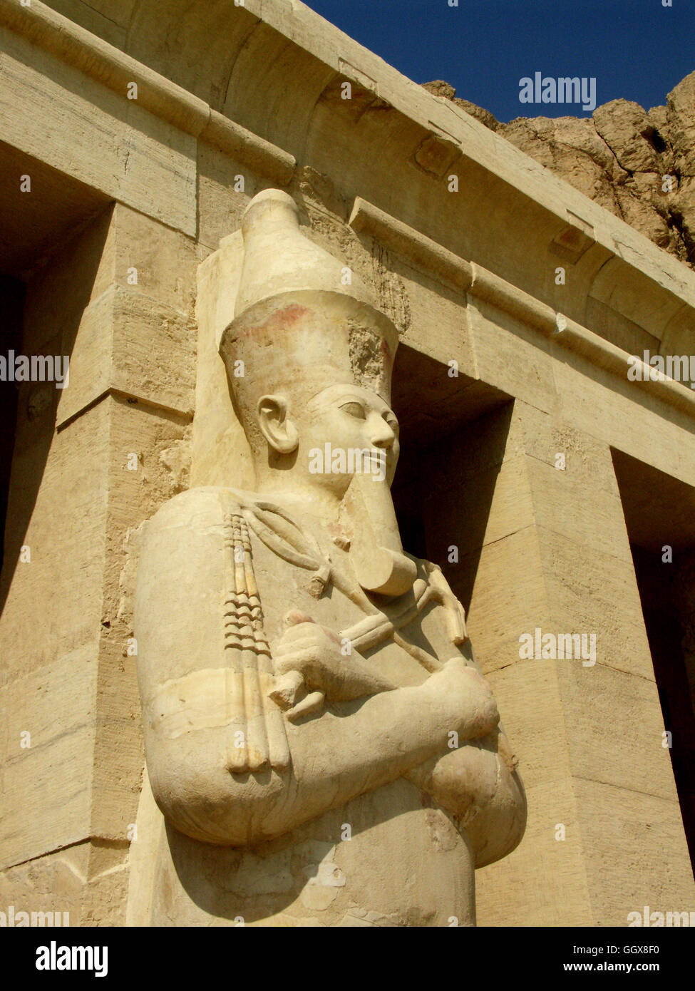 Column statue of pharaoh holding the crook and flail at the Mortuary ...