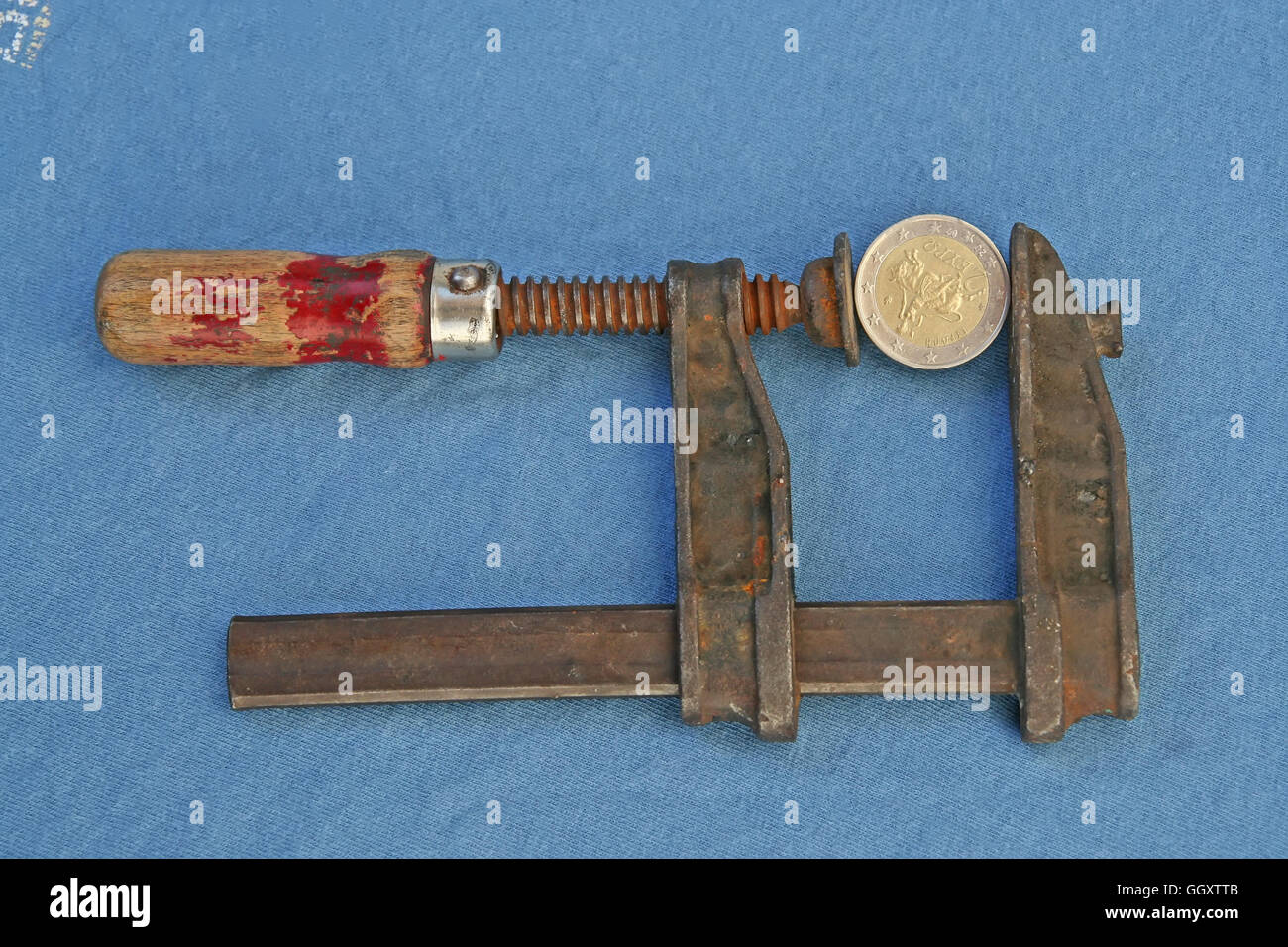 Euro coin in a clamp Stock Photo - Alamy