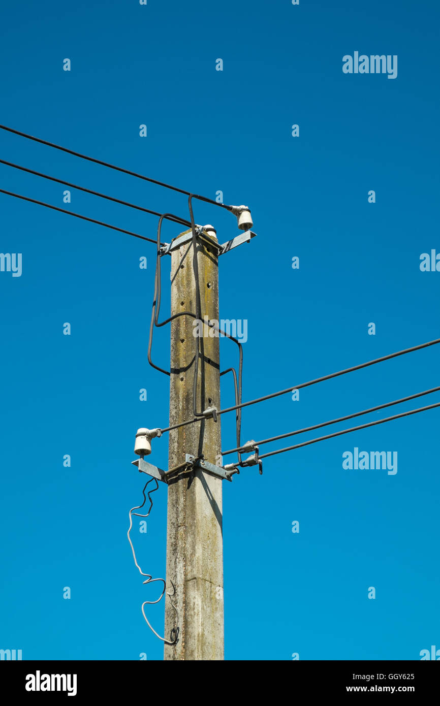 Unsafe looking concrete electricity pylon Stock Photo - Alamy