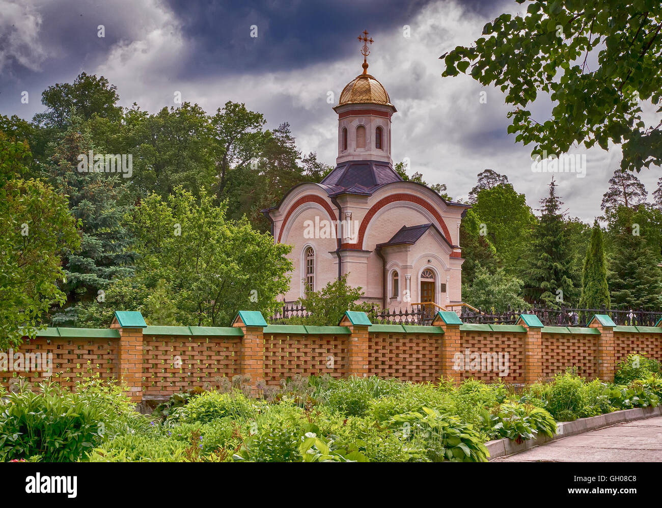A beautiful Orthodox temple located on a hill surrounded by flowers and ...