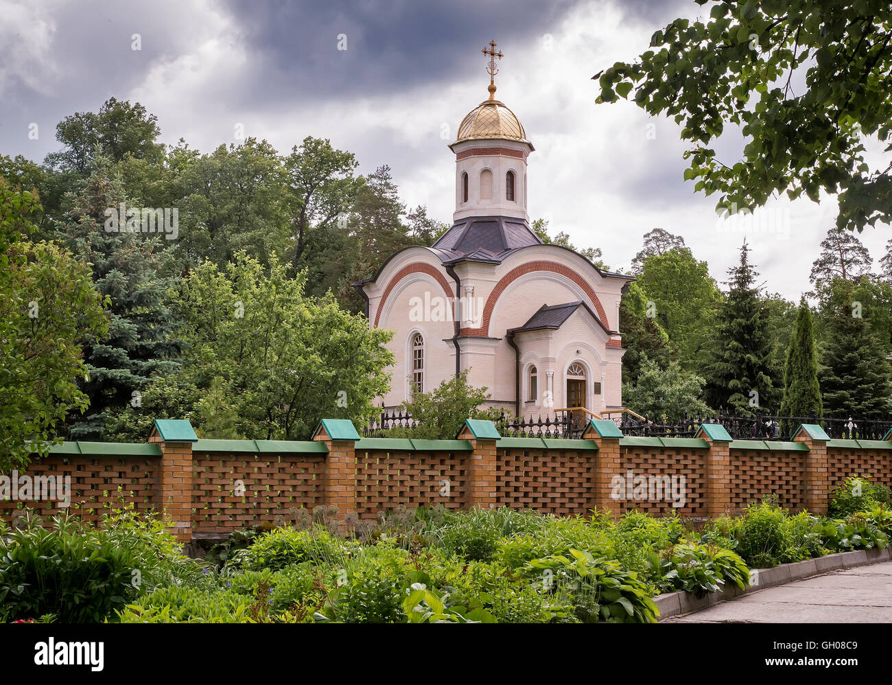 A beautiful Orthodox temple located on a hill surrounded by flowers and ...