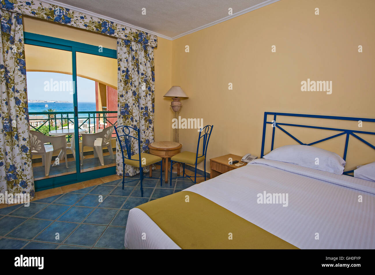 Interior design of a luxury tropical hotel resort bedroom with balcony ...