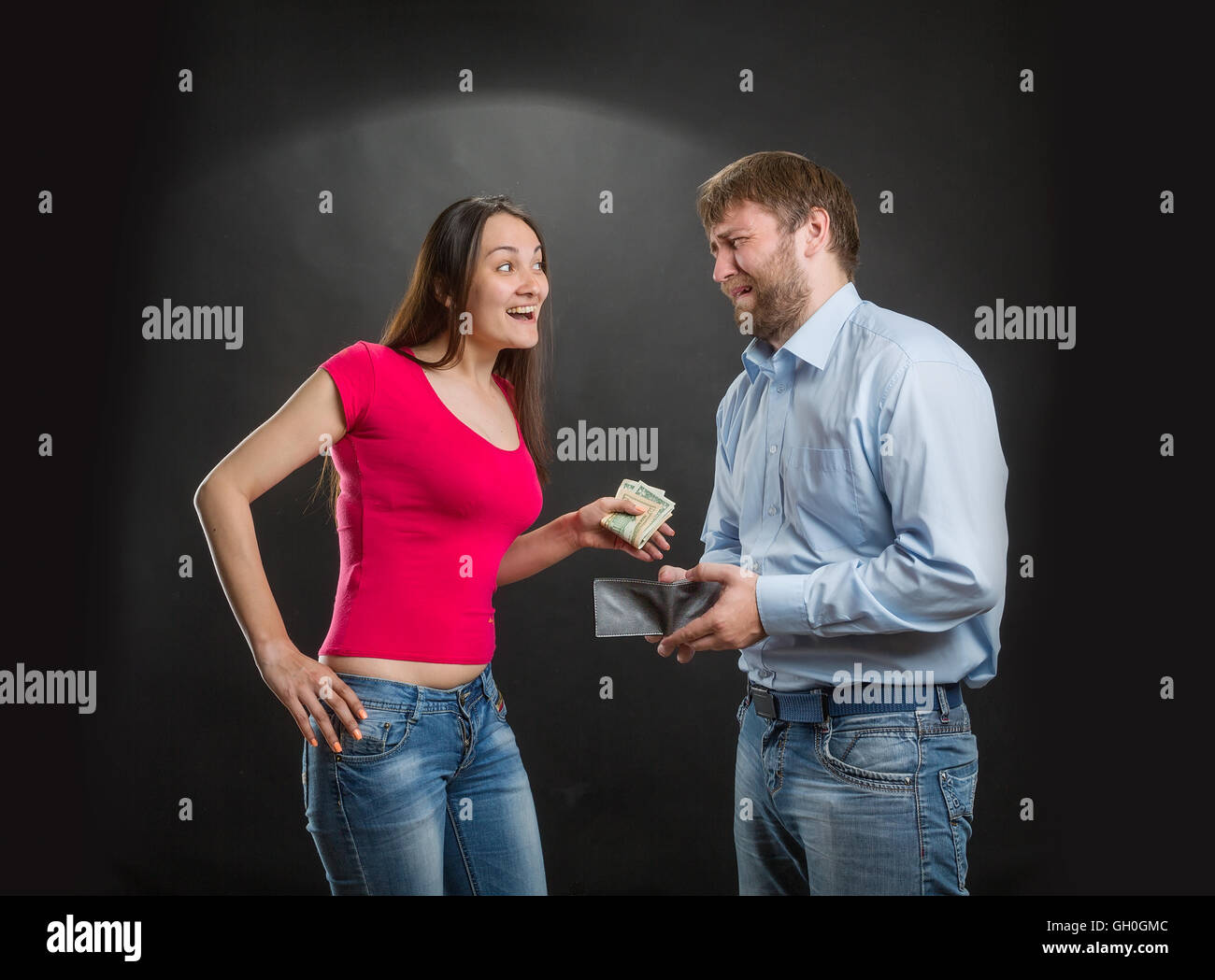 Woman taking husband's money Stock Photo - Alamy