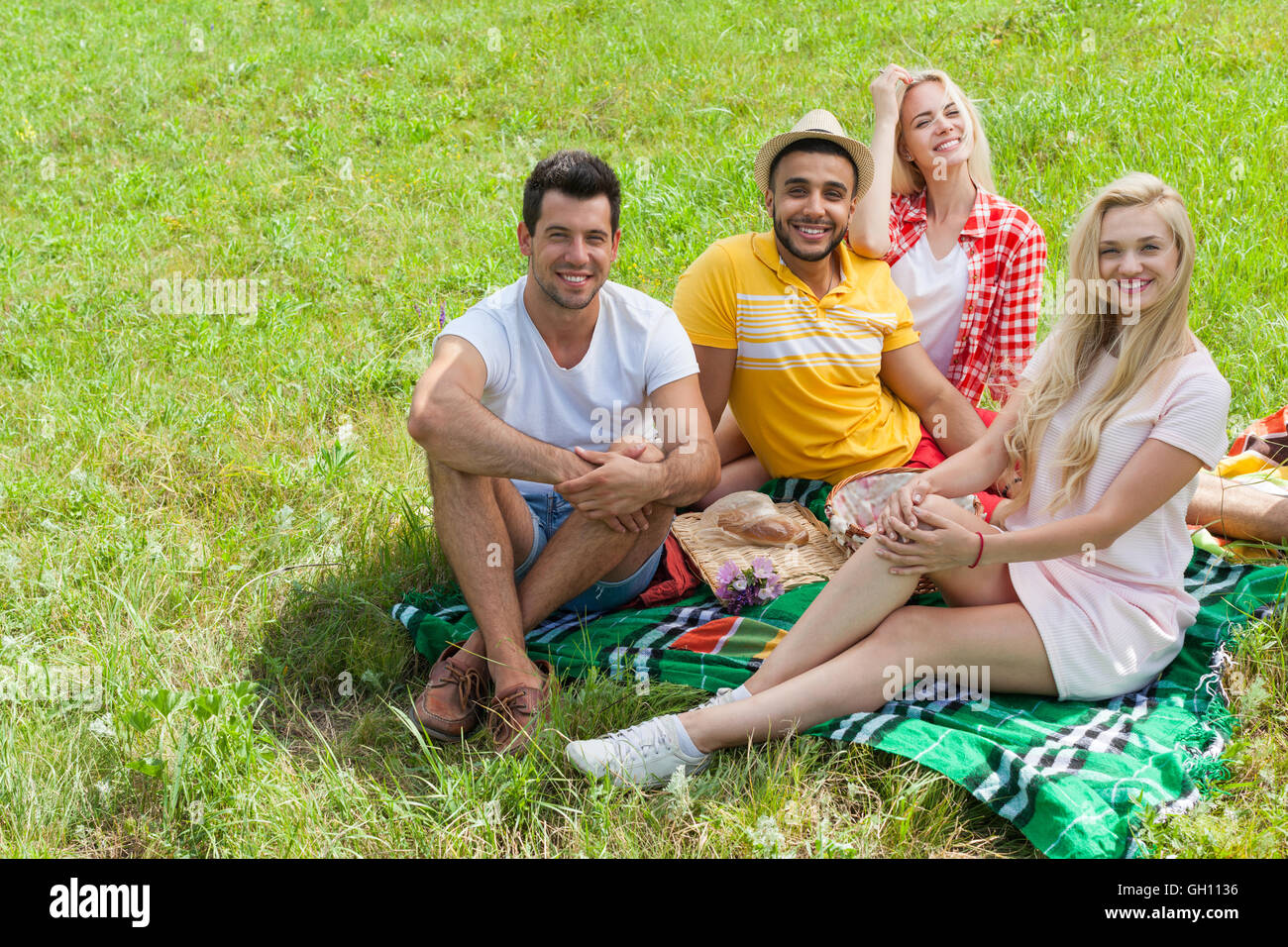 Friends picnic people group sitting blanket outdoor green grass Stock ...