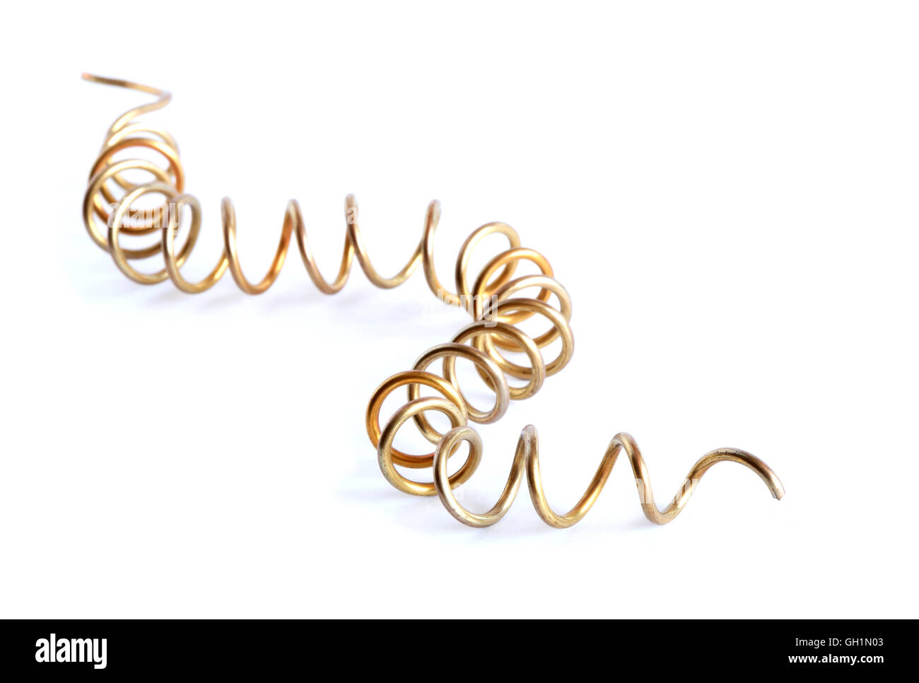 Copper wire spring on white background Stock Photo - Alamy