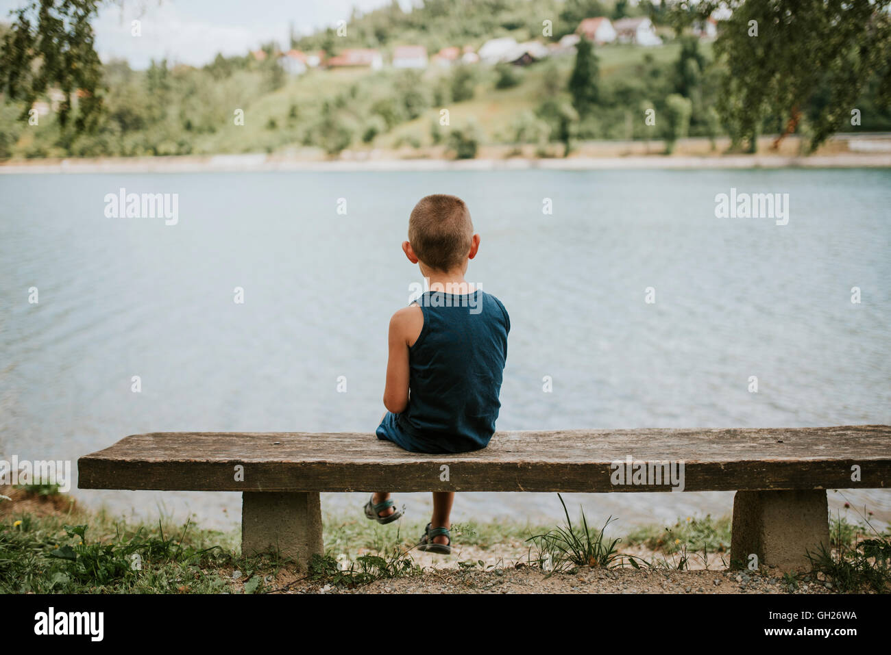 Small lonely boy sitting alone hi-res stock photography and images - Alamy