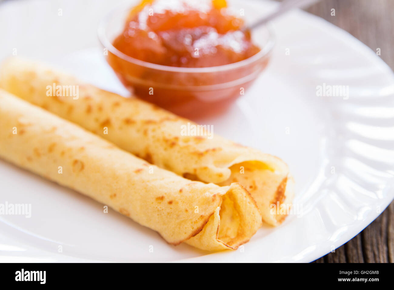 Dessert with tasty apricot roll crepes Stock Photo - Alamy