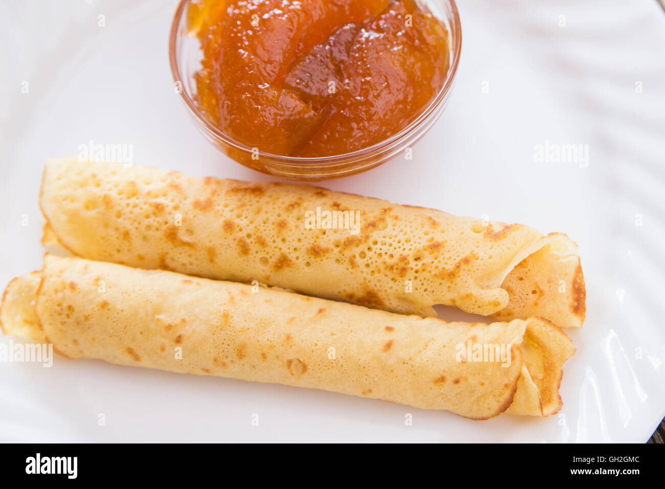 Dessert with tasty apricot roll crepes Stock Photo - Alamy