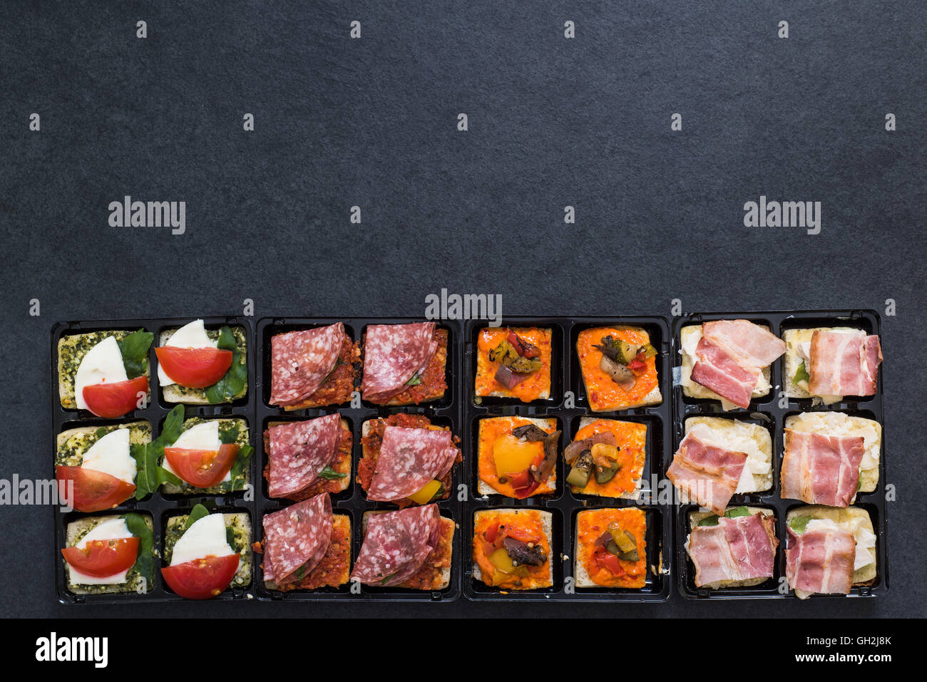 selection of antipasti spanish tapas on dark slate Stock Photo - Alamy