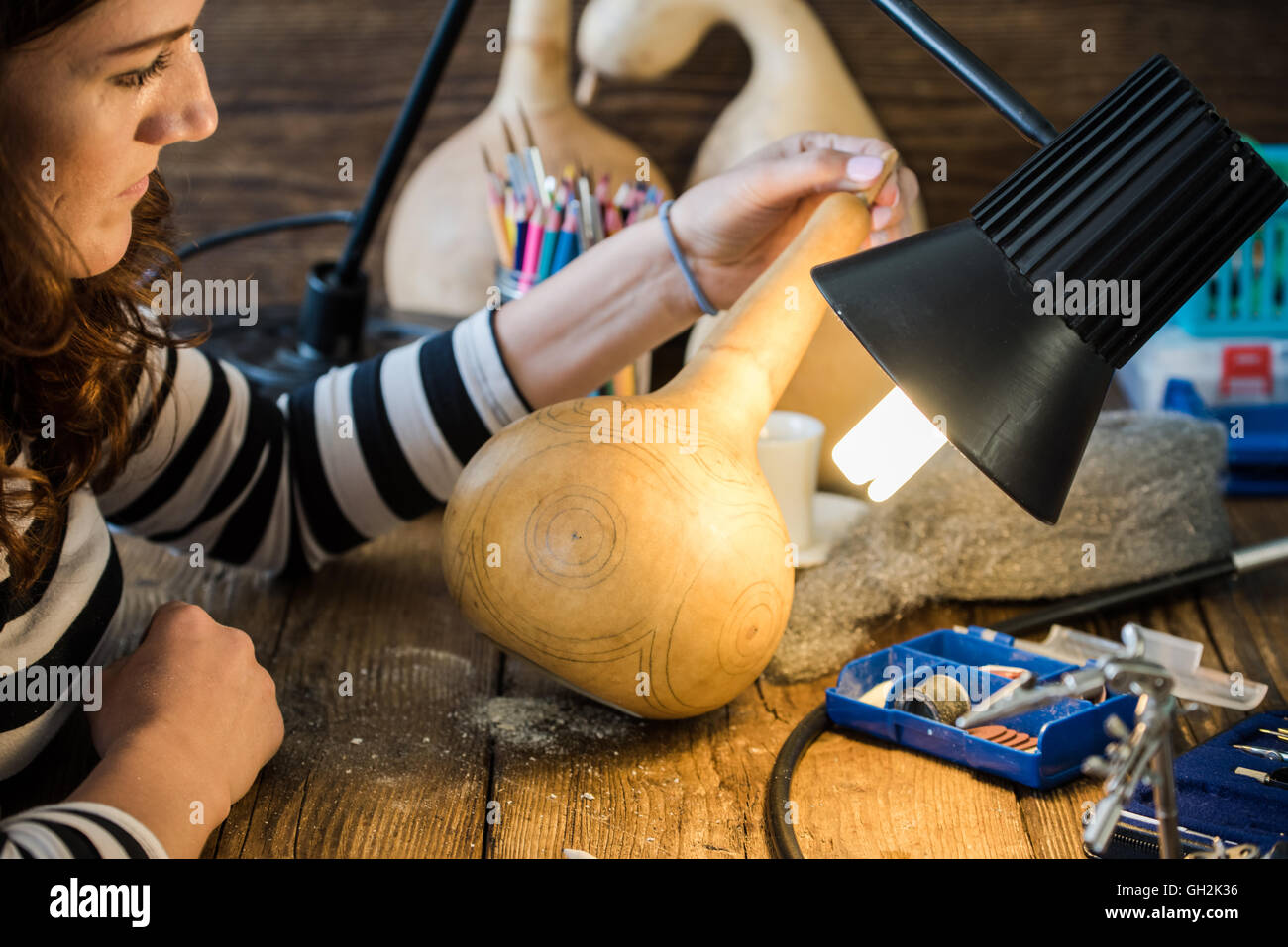 young woman concentrate on hobby creative craft in small local workshop ...
