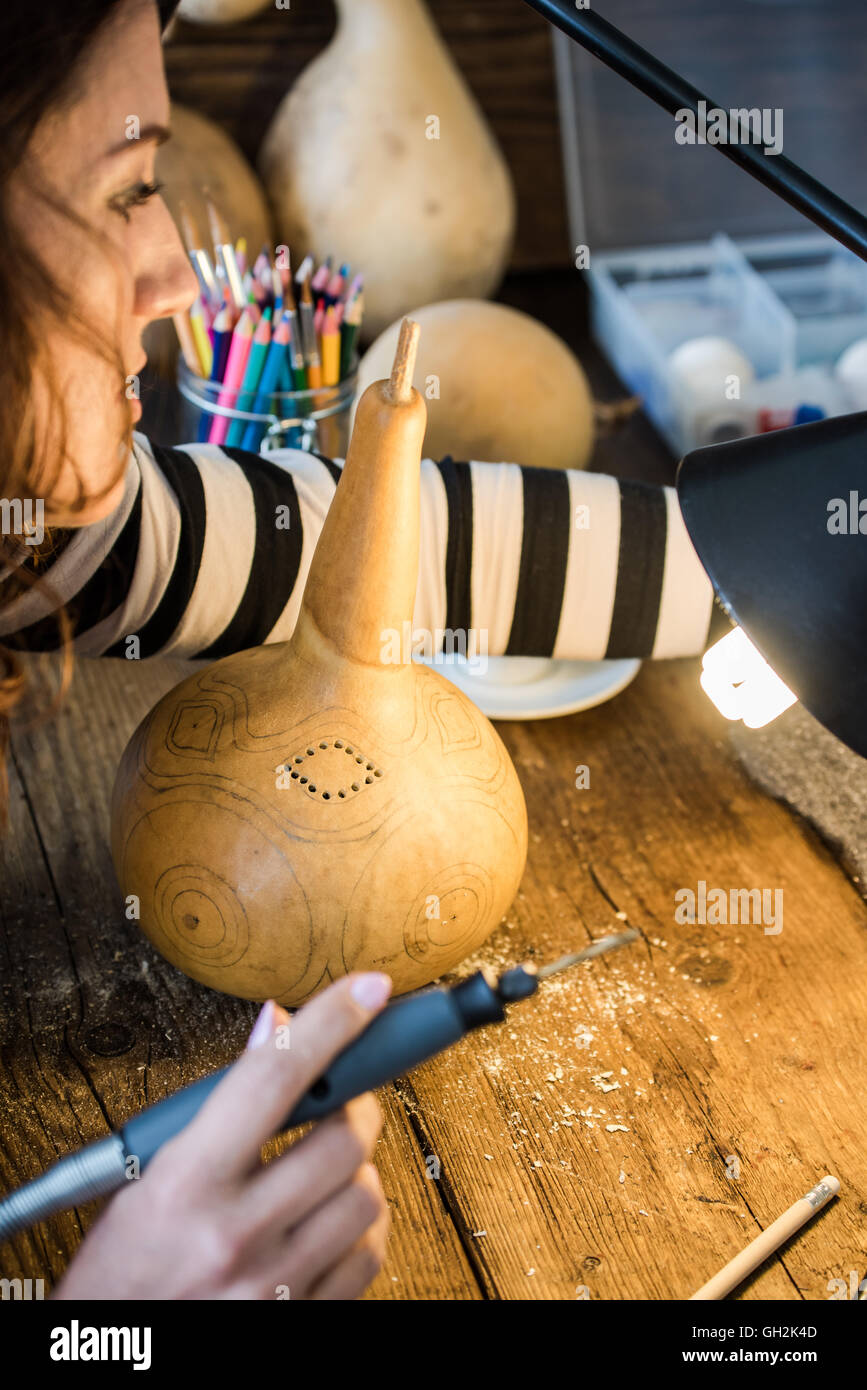 carving in calabash or gourd, creative artisan craft Stock Photo - Alamy