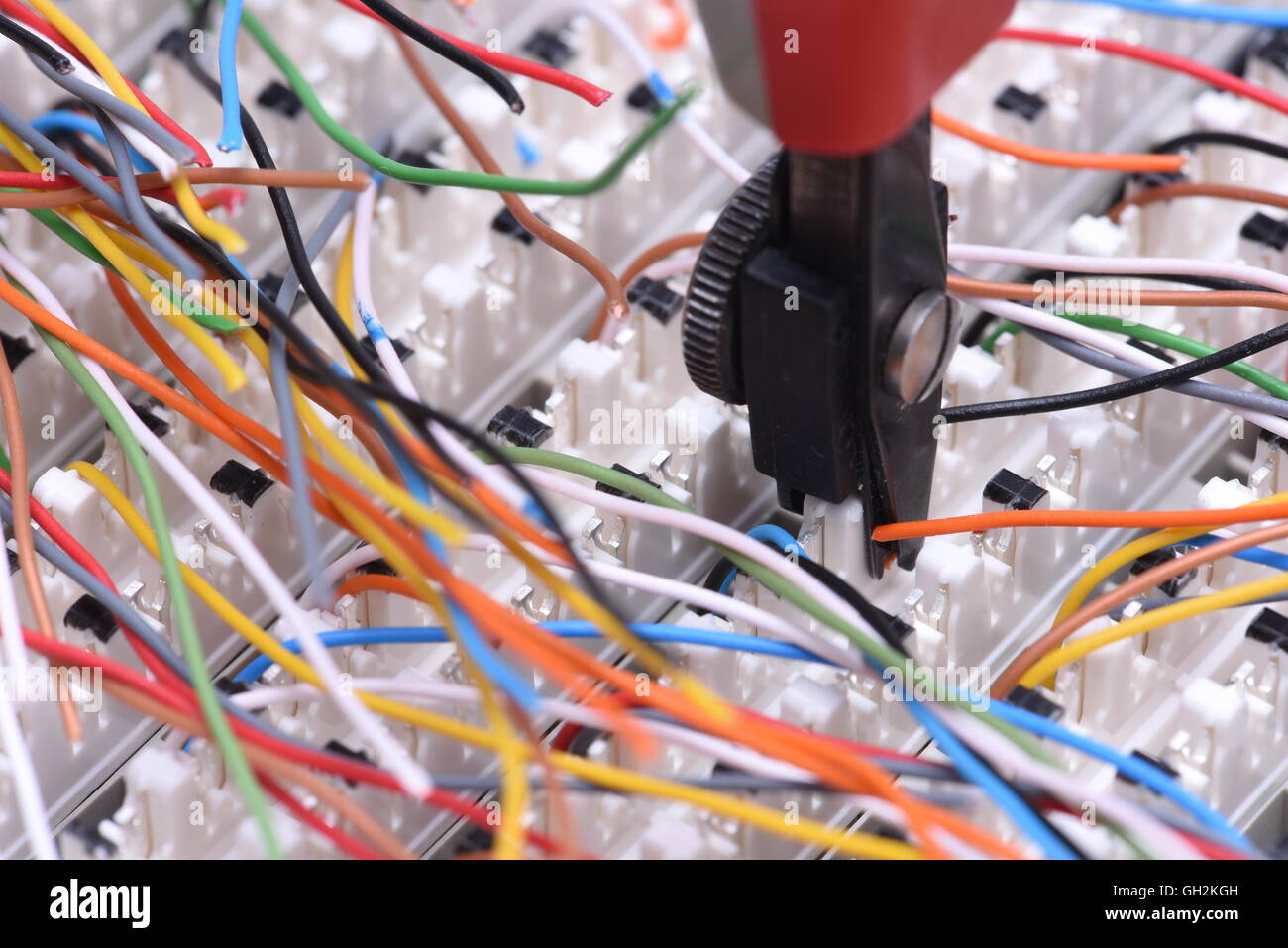 Telecommunication main distribution frame with cables and punching tool ...