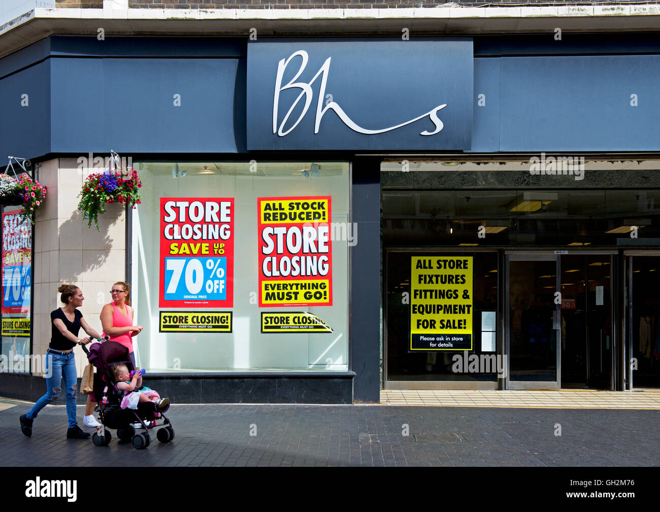 Two young women walking past branch of BHS, British Home Stores ...