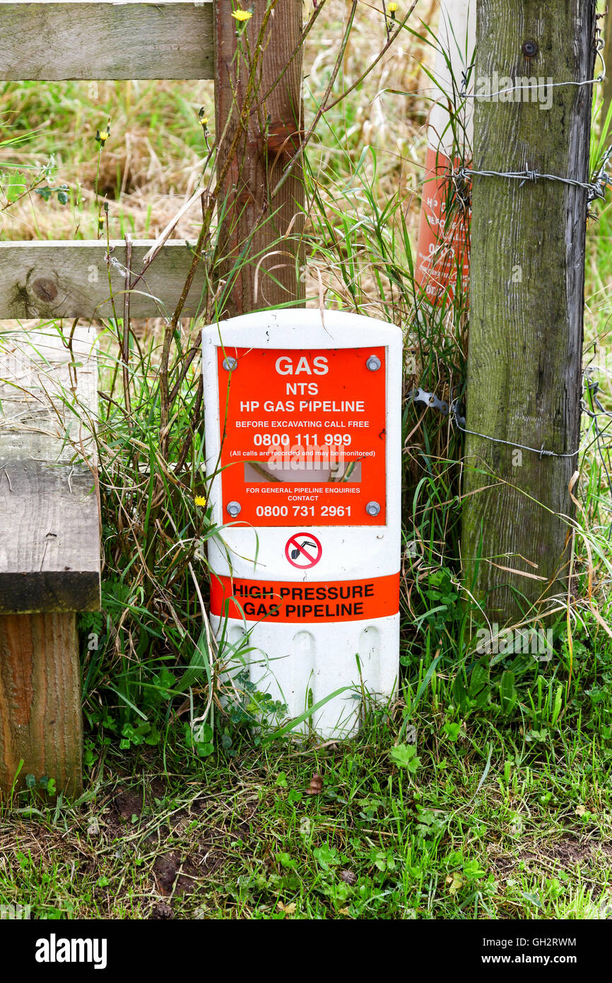 A sign next to a stile for a NTS high pressure gas pipeline England UK ...