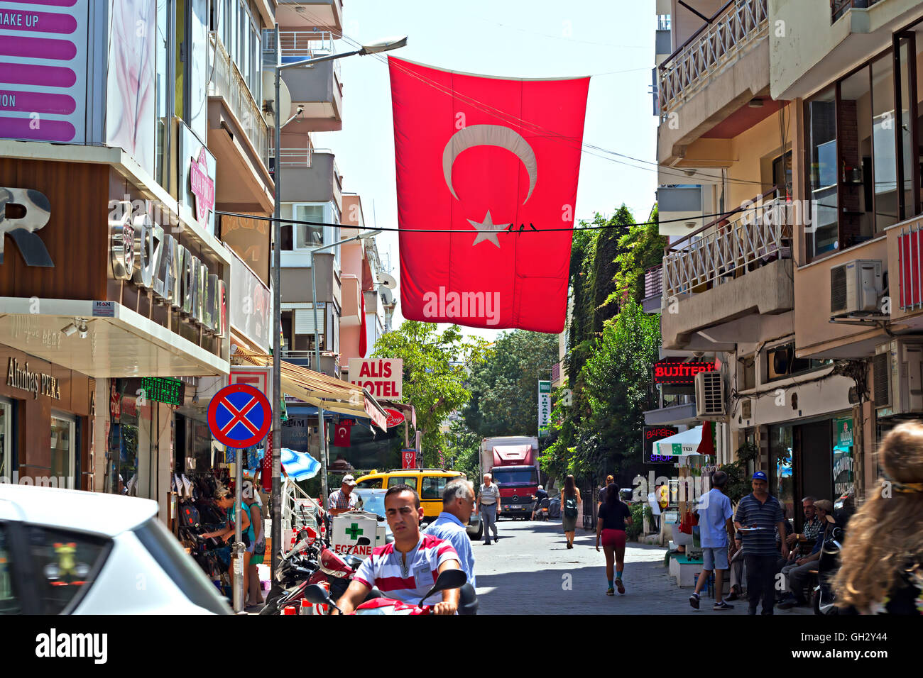 Local people walking under a giant Turkish flag in Kusadasi Turkey ...