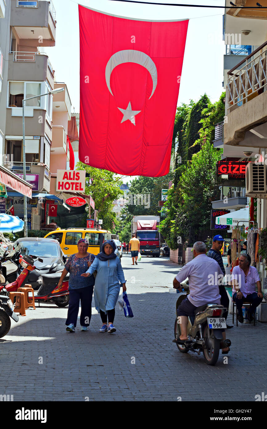 Local people walking under a giant Turkish flag in Kusadasi Turkey ...