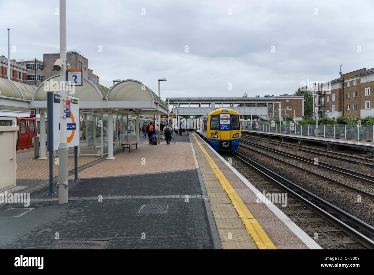 A London overground train departing at Olympia station Stock Photo - Alamy