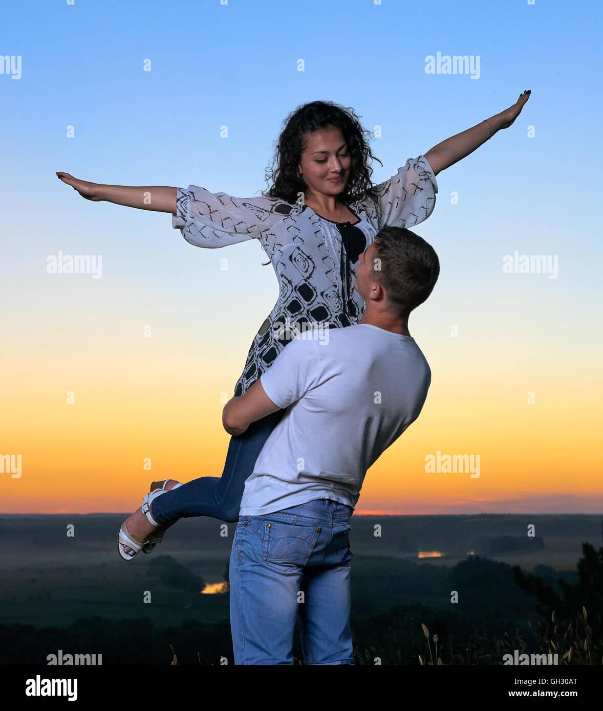 romantic couple having fun at sunset on outdoor, beautiful landscape ...