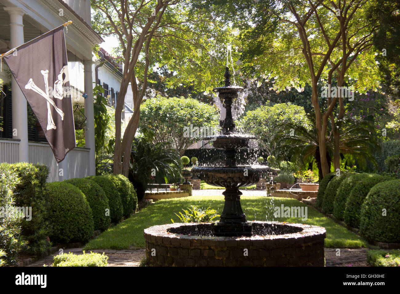 Courtyard w/ fountain & pirate flag of a residence in Charleston's ...