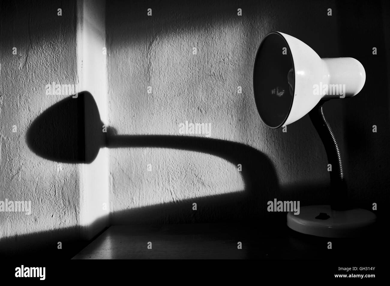 A lamp casting its shadow on the wall Stock Photo - Alamy