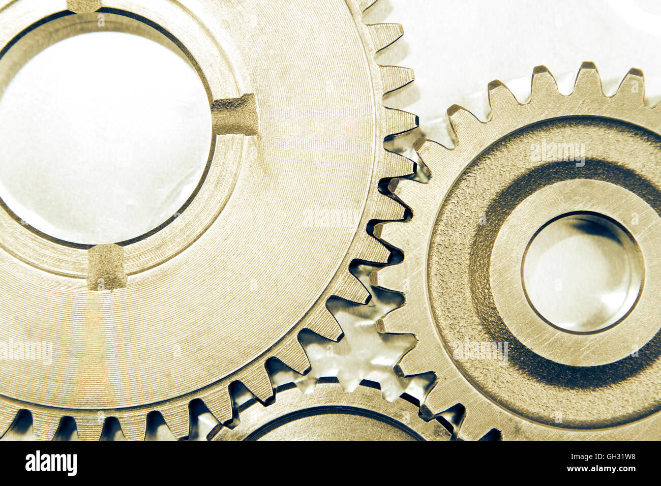 Metal cog gears joining together Stock Photo - Alamy